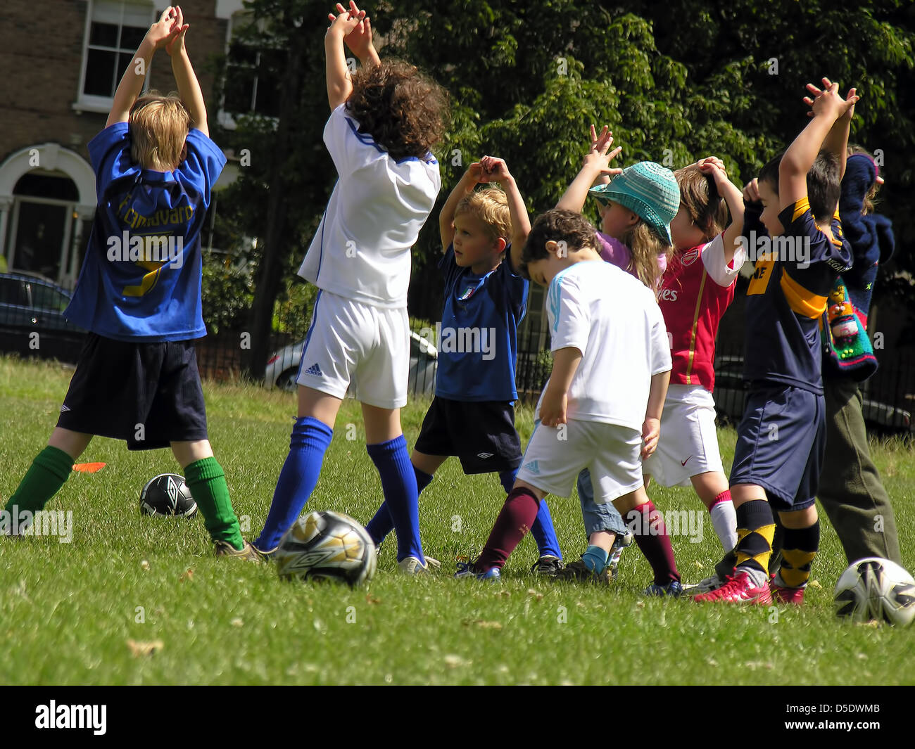 Little kids on football training in the park Stock Photo - Alamy