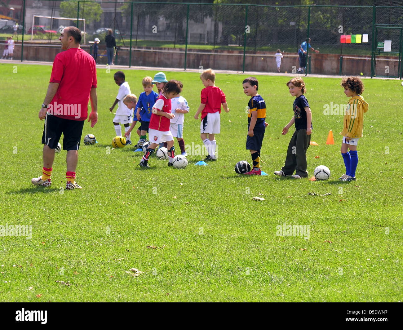 Kids playing football in the park Stock Photo - Alamy