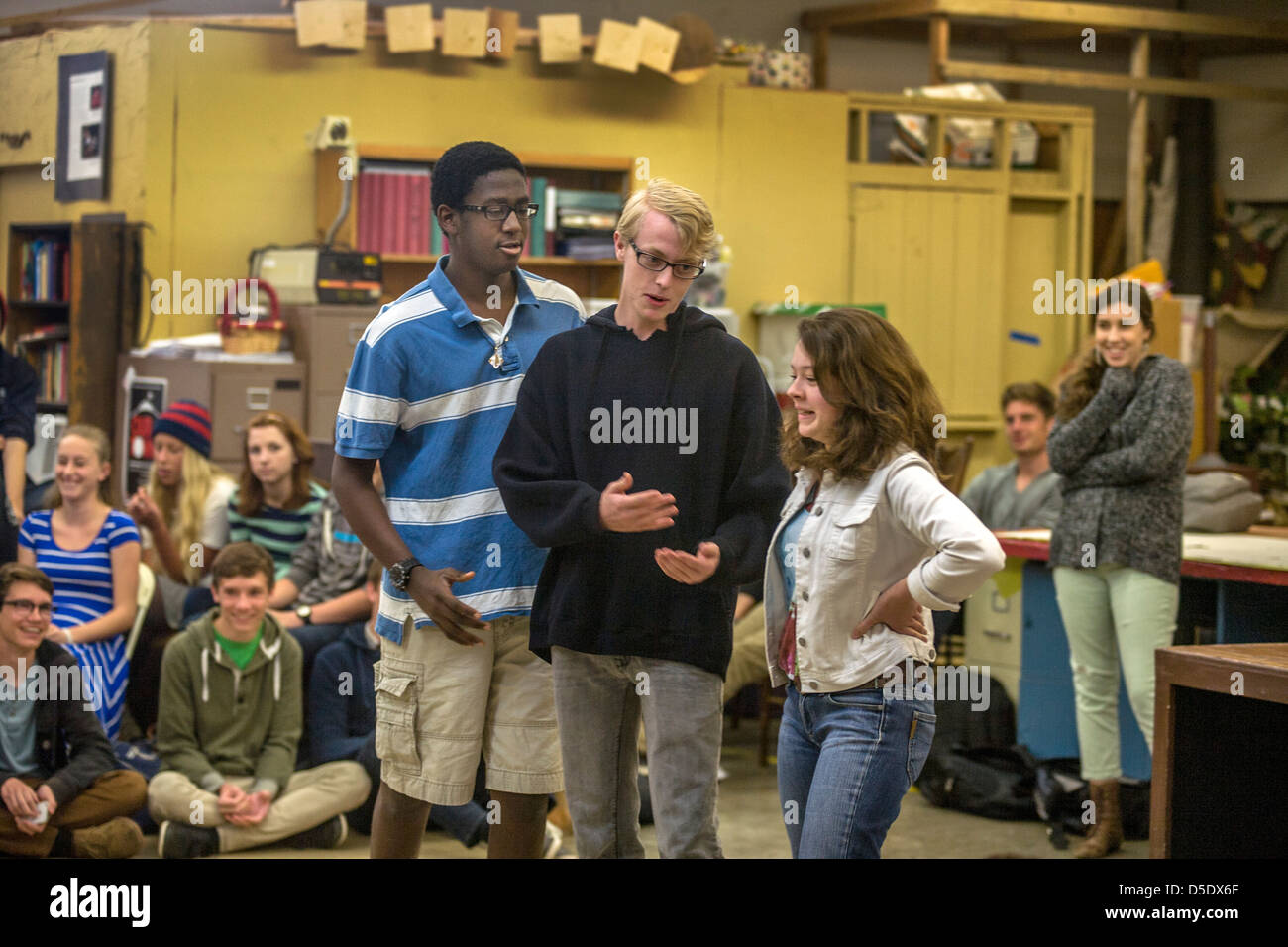 As their multiethnic classmates watch, high school drama drama students ...