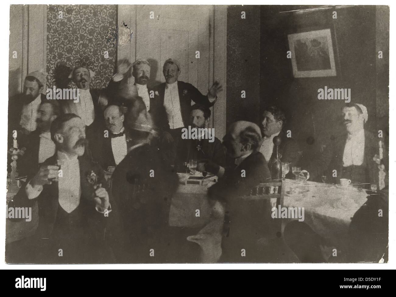 This black-and-white photograph depicts artists gathered at a banquet ...