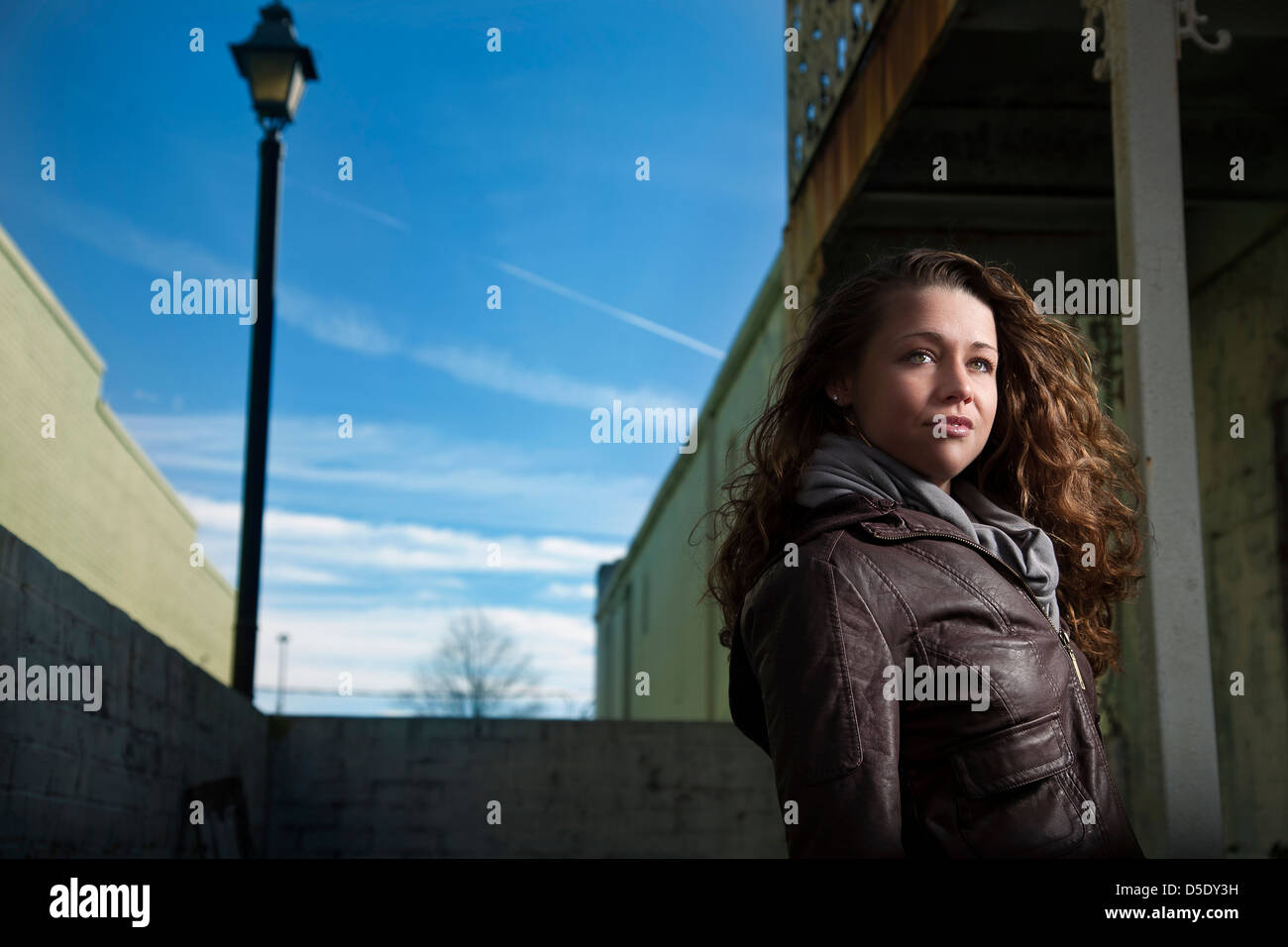 Woman standing between buildings Stock Photo - Alamy