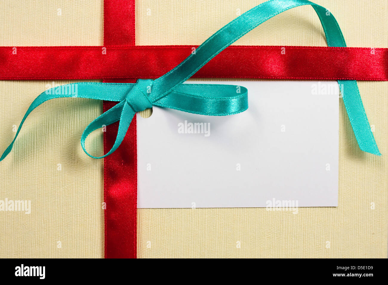 Blank gift tag tied with a bow of red satin ribbon Stock Photo - Alamy