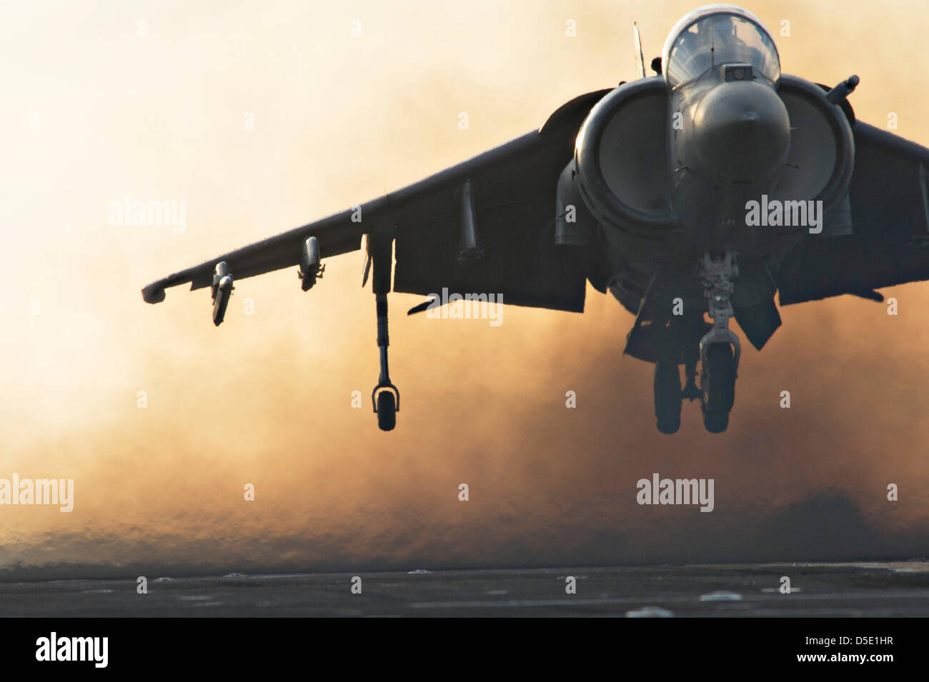 A US Marine Corps AV-8B Harrier fighter aircraft performs a vertical ...