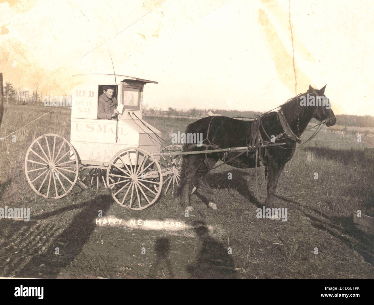 A photograph showing a rural mail carrier with a horse-drawn wagon ...