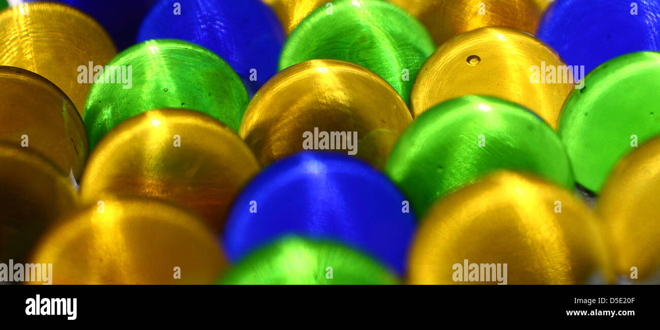 Blue, yellow and green marbles on a white background Stock Photo - Alamy