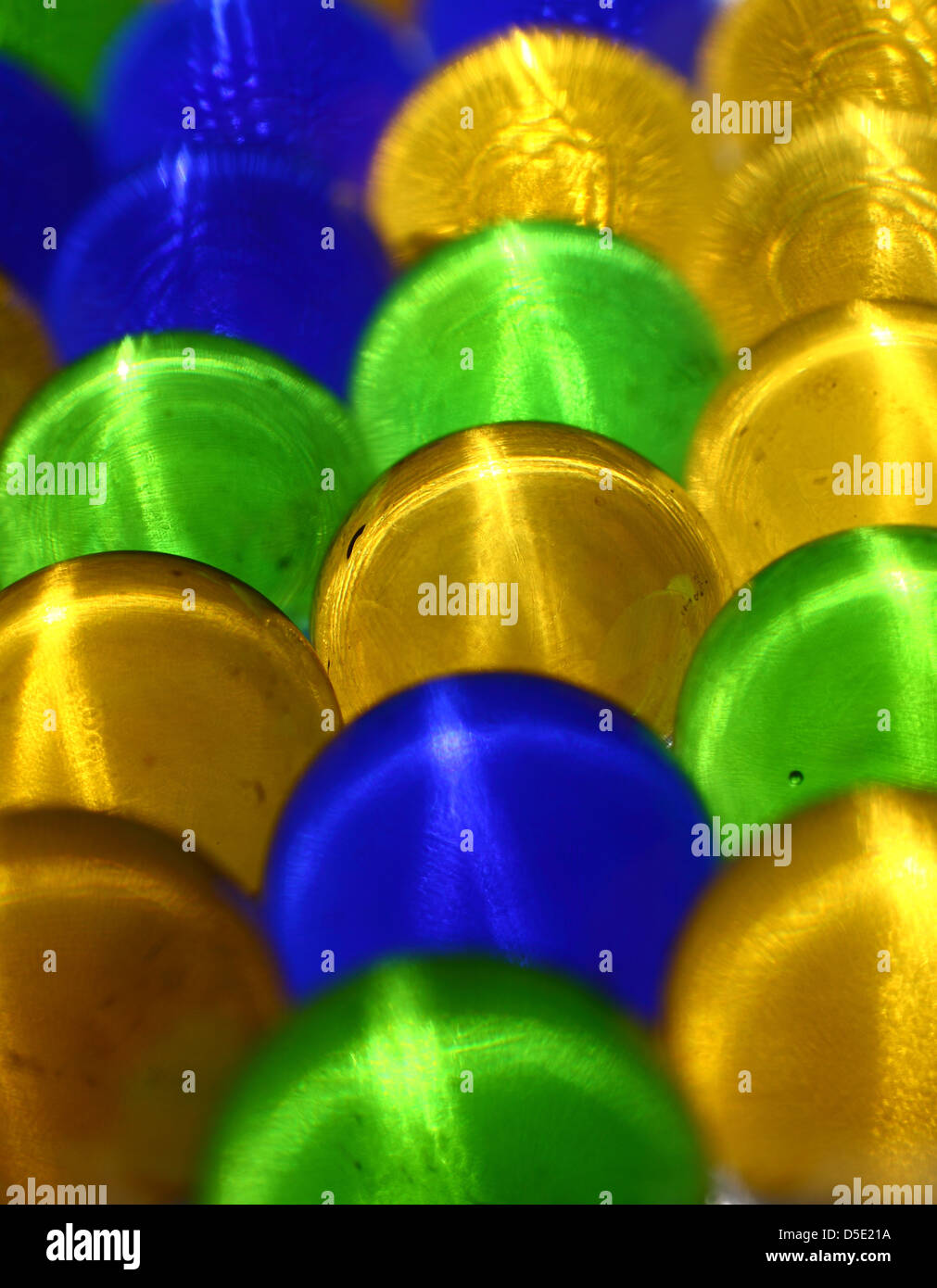 Blue, yellow and green marbles on a white background Stock Photo - Alamy