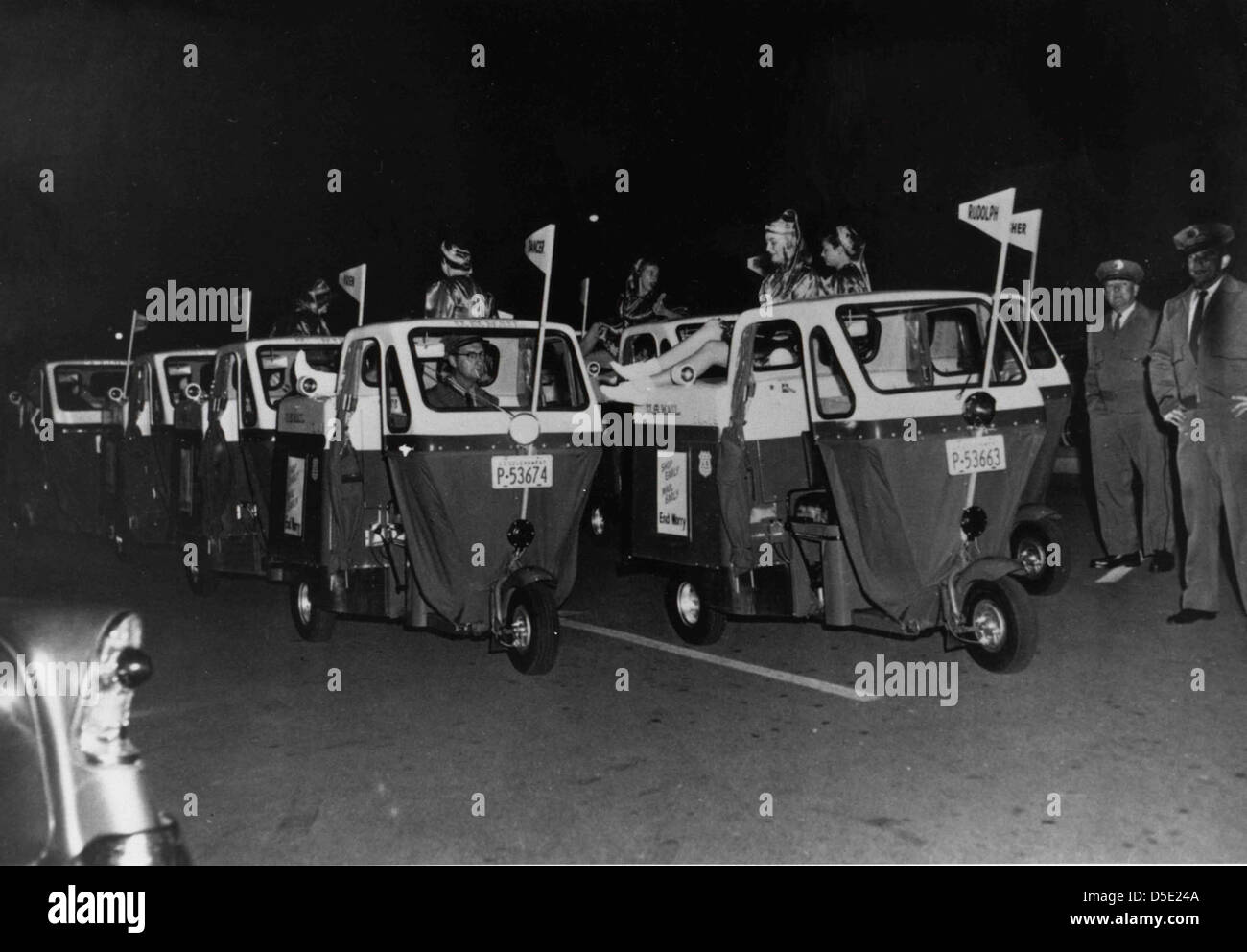 A parade featuring the Cushman Mailster, a small mail delivery vehicle ...