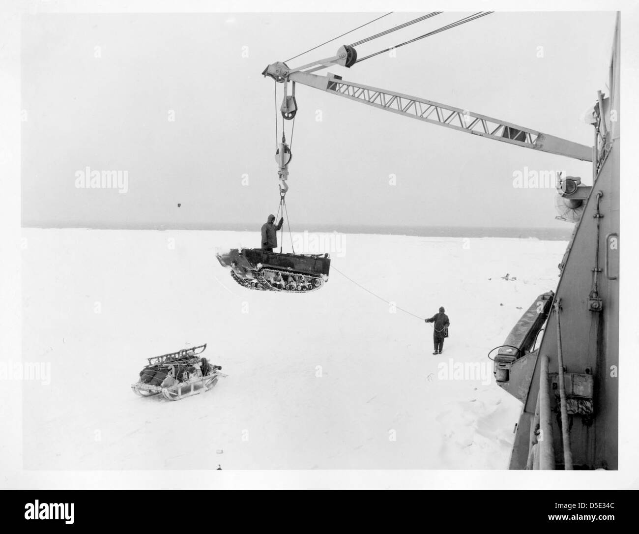 Members of the Operation Windmill Expedition are seen unloading ...