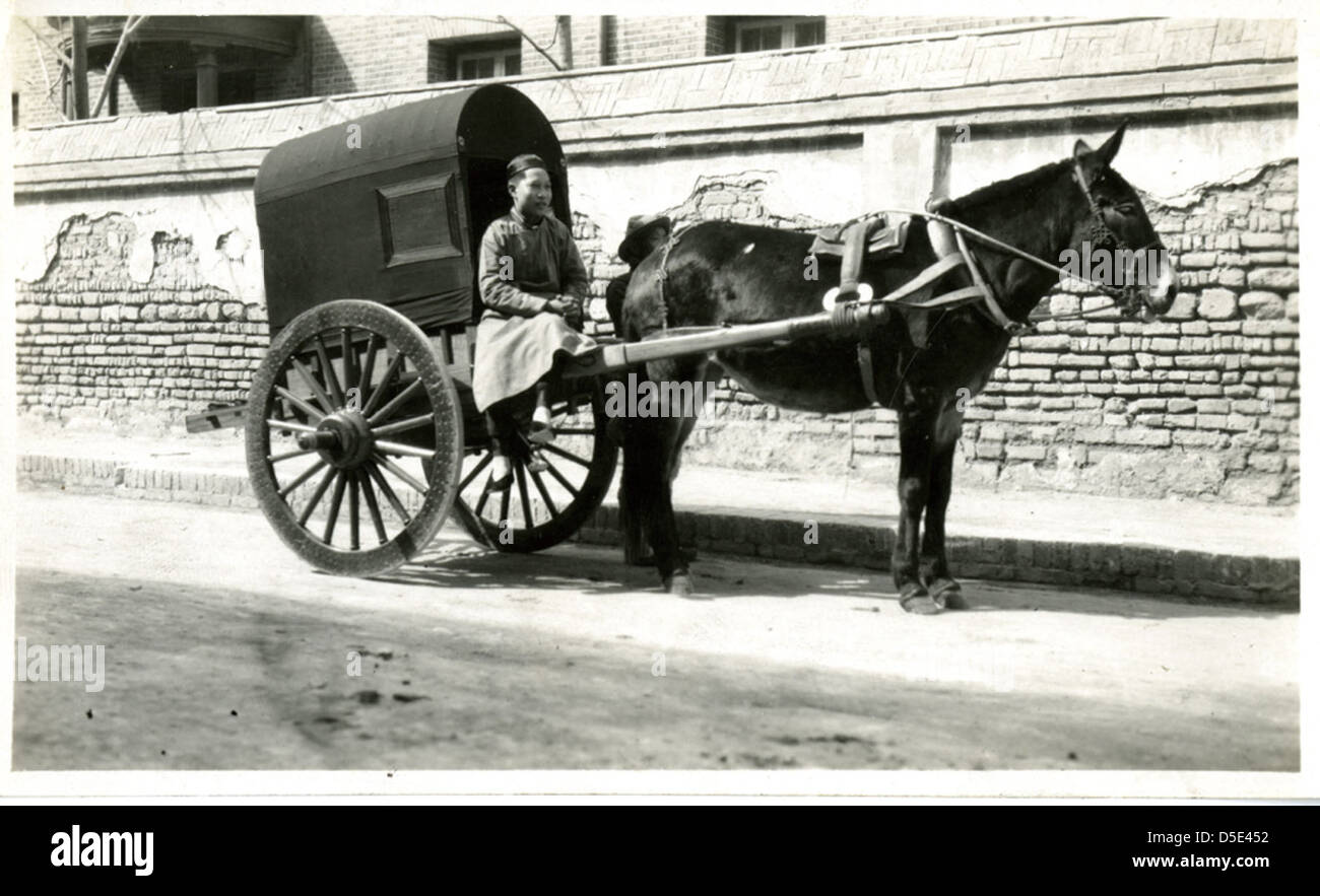 A Chinese man is shown driving a horse-drawn cart in a scene from early ...