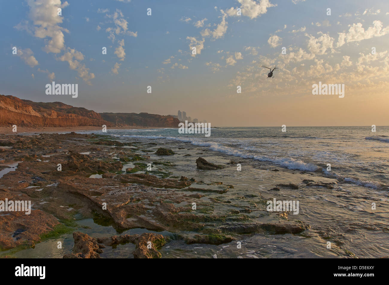 Helicopter flying near sea shore Stock Photo - Alamy