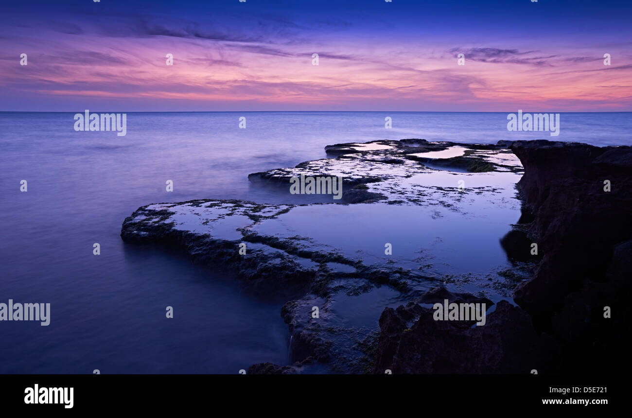 Curved Sea Shore after sunset Stock Photo - Alamy