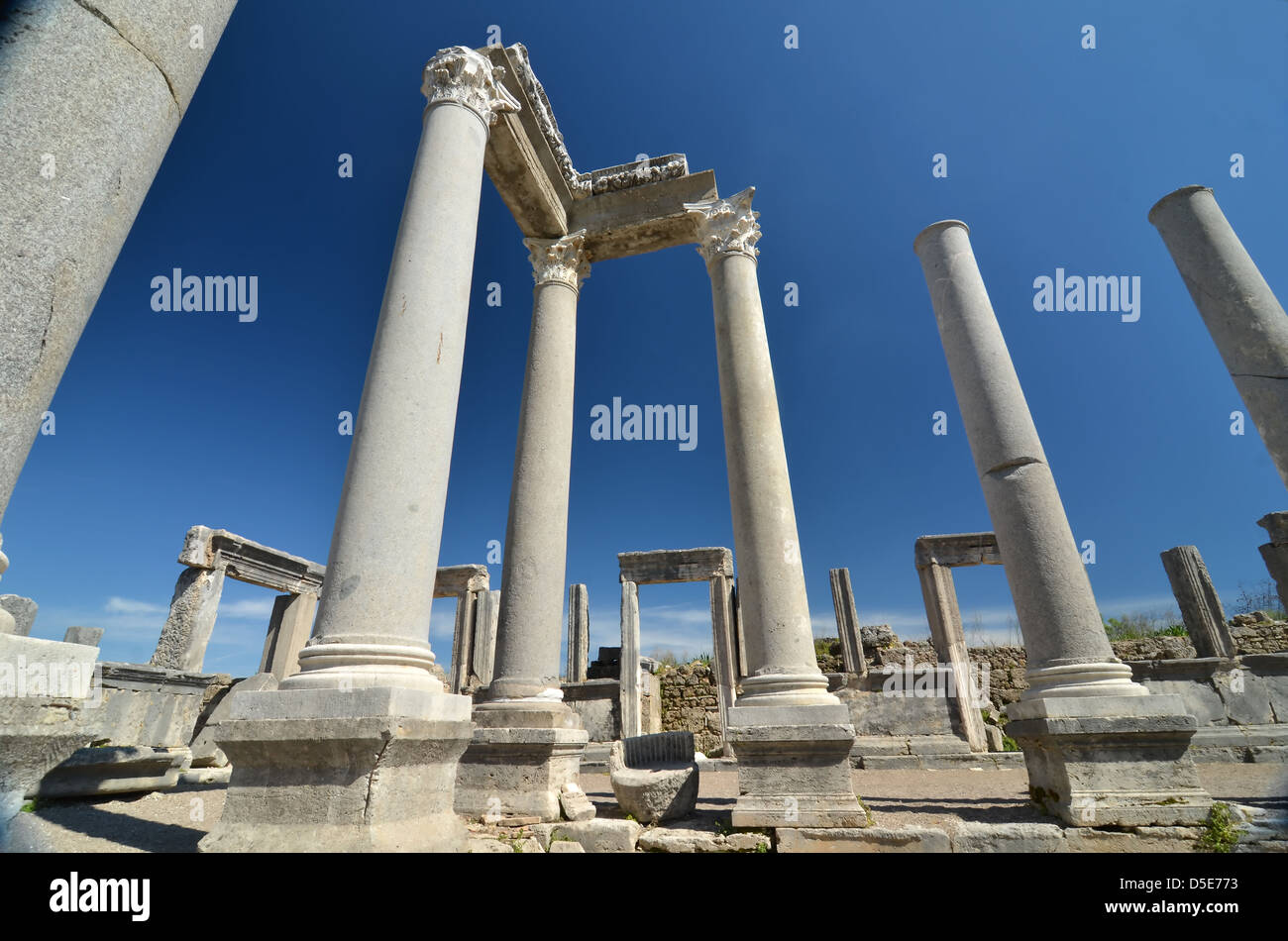 Remains of ancient greek columns and doorways together with intact ...