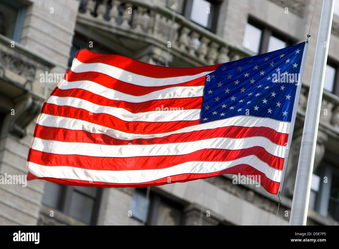 The flag of the United States of America against a building block Stock ...