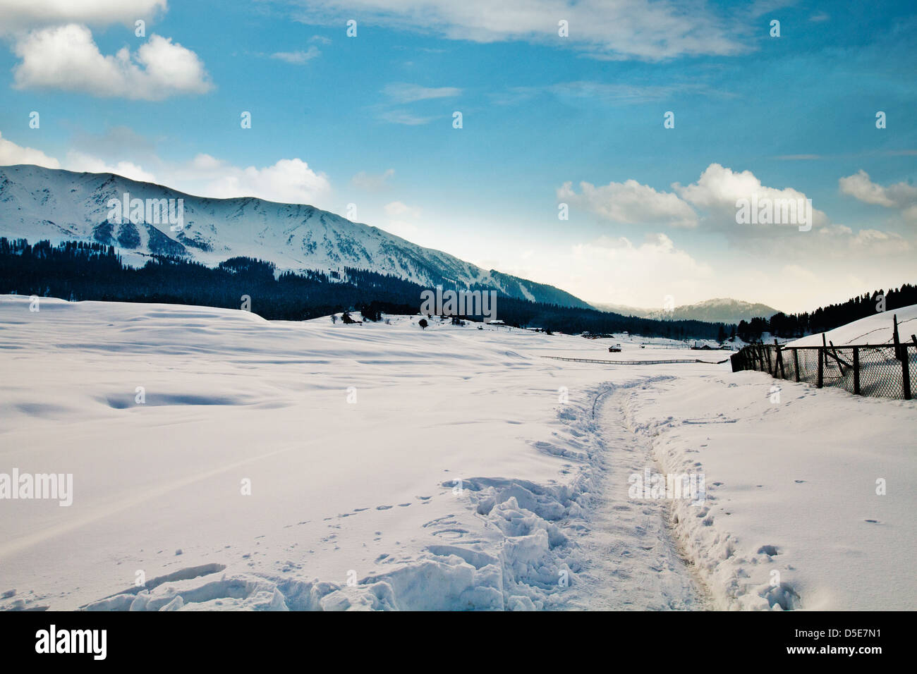 Snow covered landscape with mountain range in the background, Kashmir ...