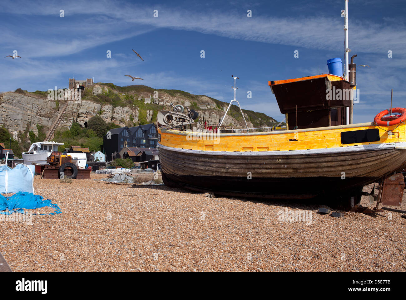 Fishing trawler or boat on beach in hastings with hill in background ...