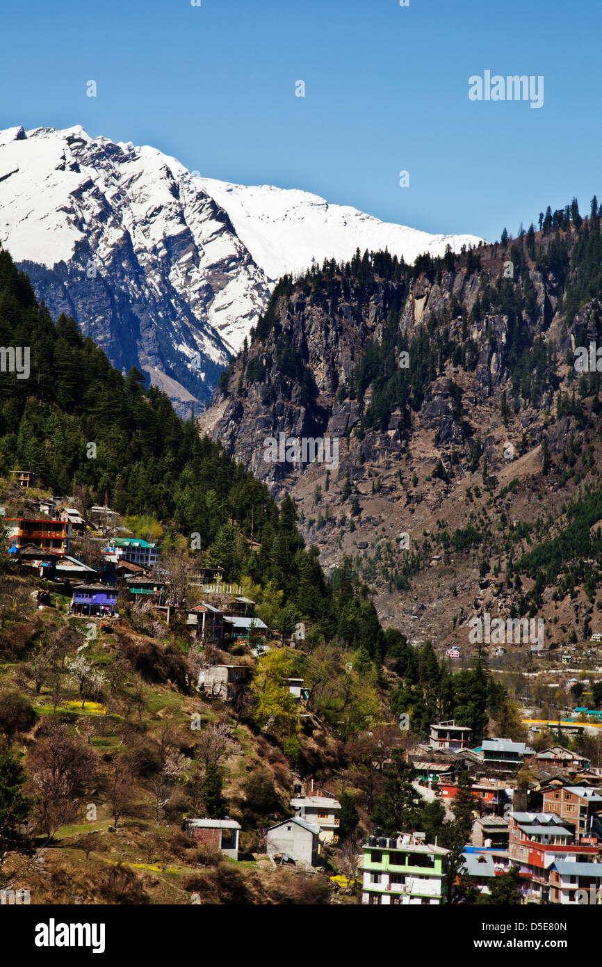 Town with snow covered mountains in the background, Manali, Himachal ...
