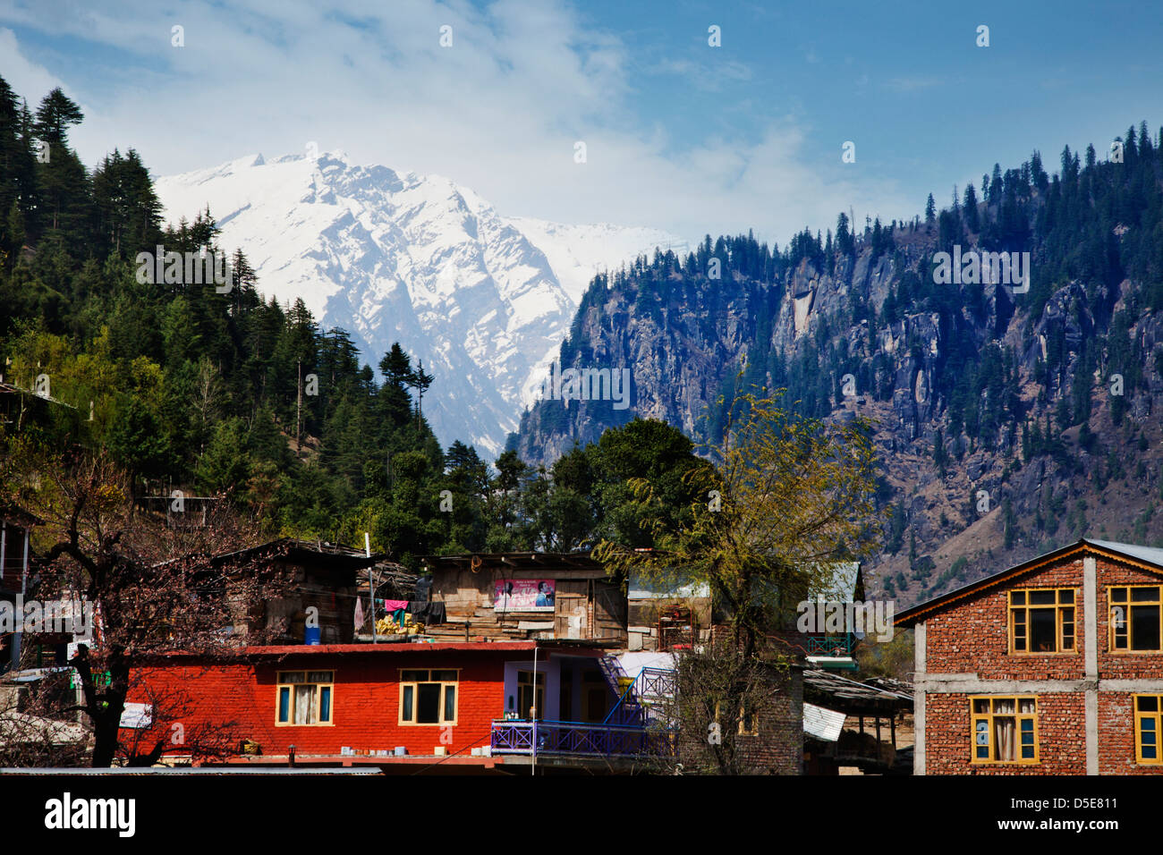 Town with snow covered mountains in the background, Manali, Himachal ...