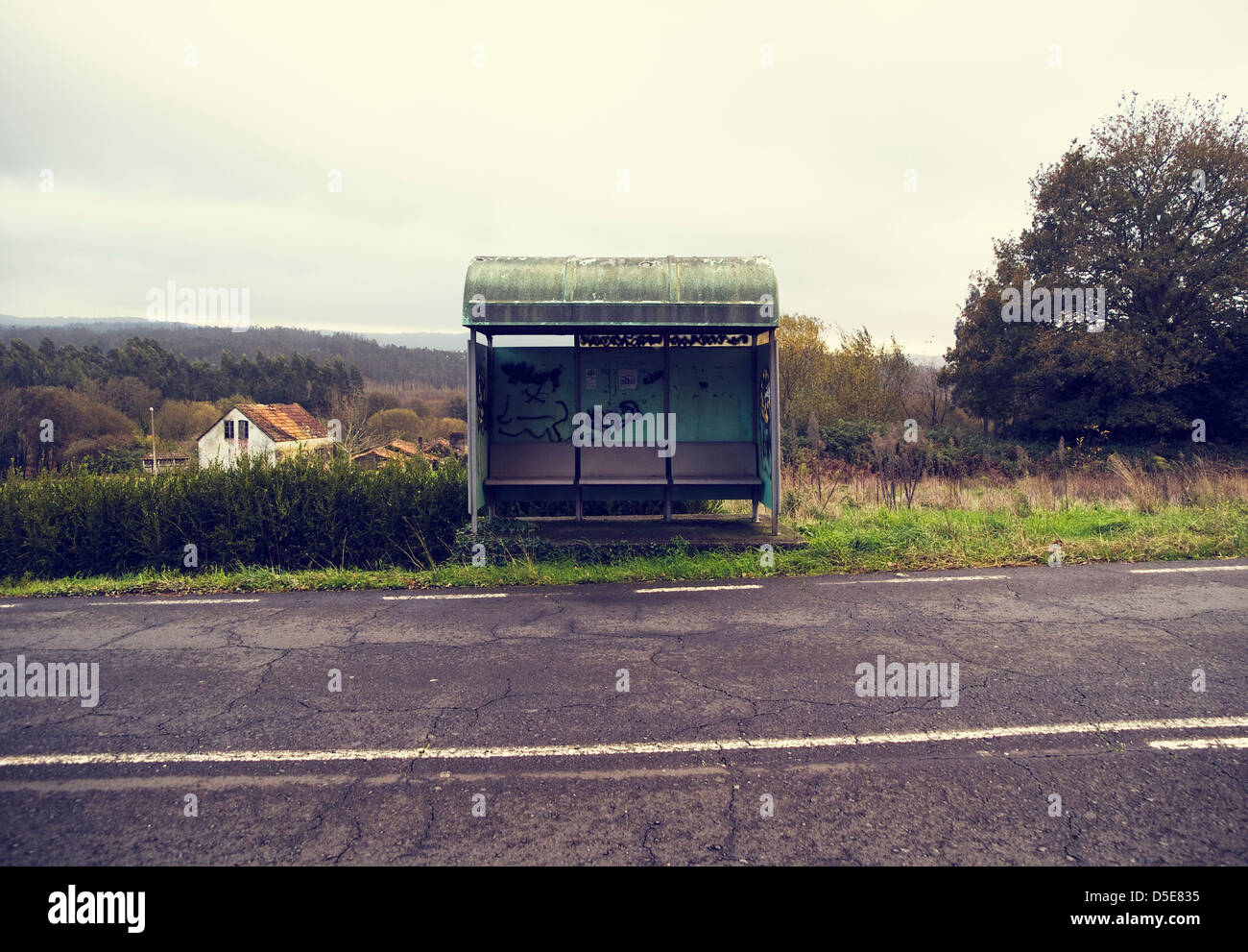 A bus stop with a semi-abandoned vintage processing to give a more ...