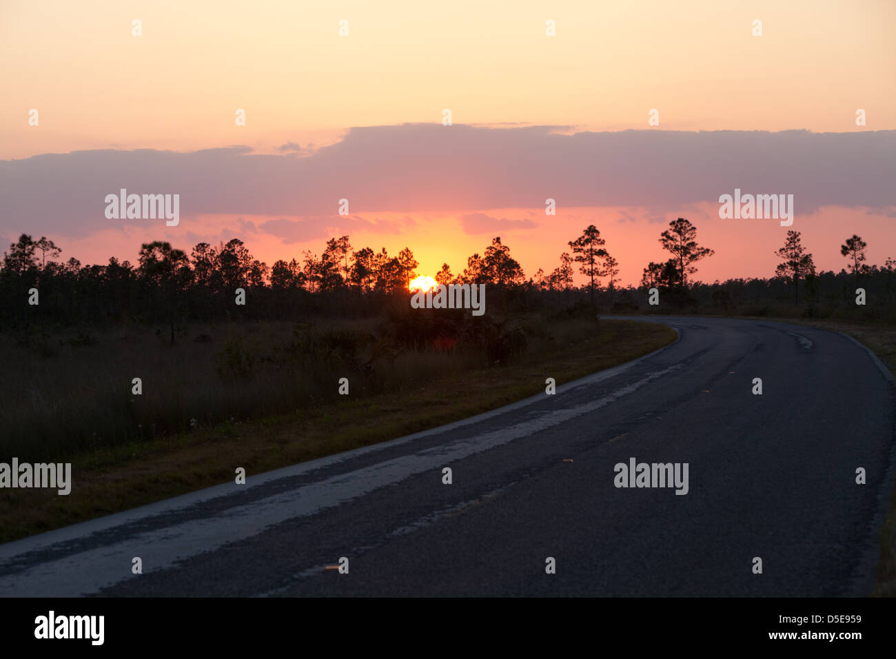 Sunset on the horizon road Stock Photo - Alamy
