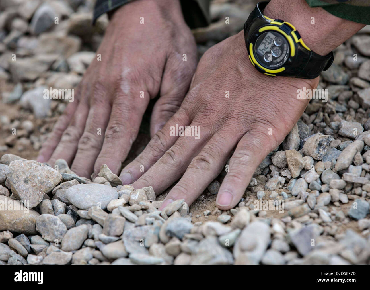 An Afghan commando from Special Operations Kandak searches for an ...