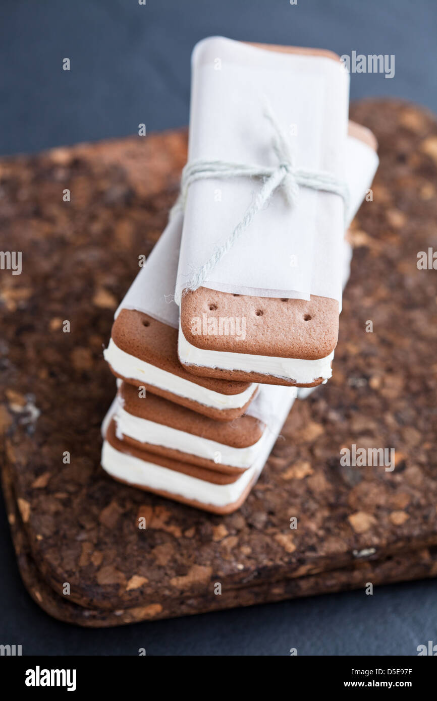 Closeup of stack of vanilla ice cream biscuits wrapped in white paper ...