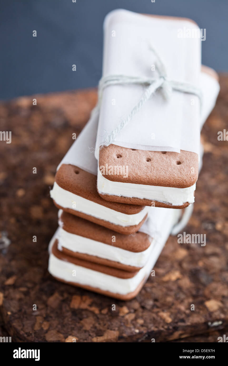 Closeup of stack of vanilla ice cream biscuits wrapped in white paper ...