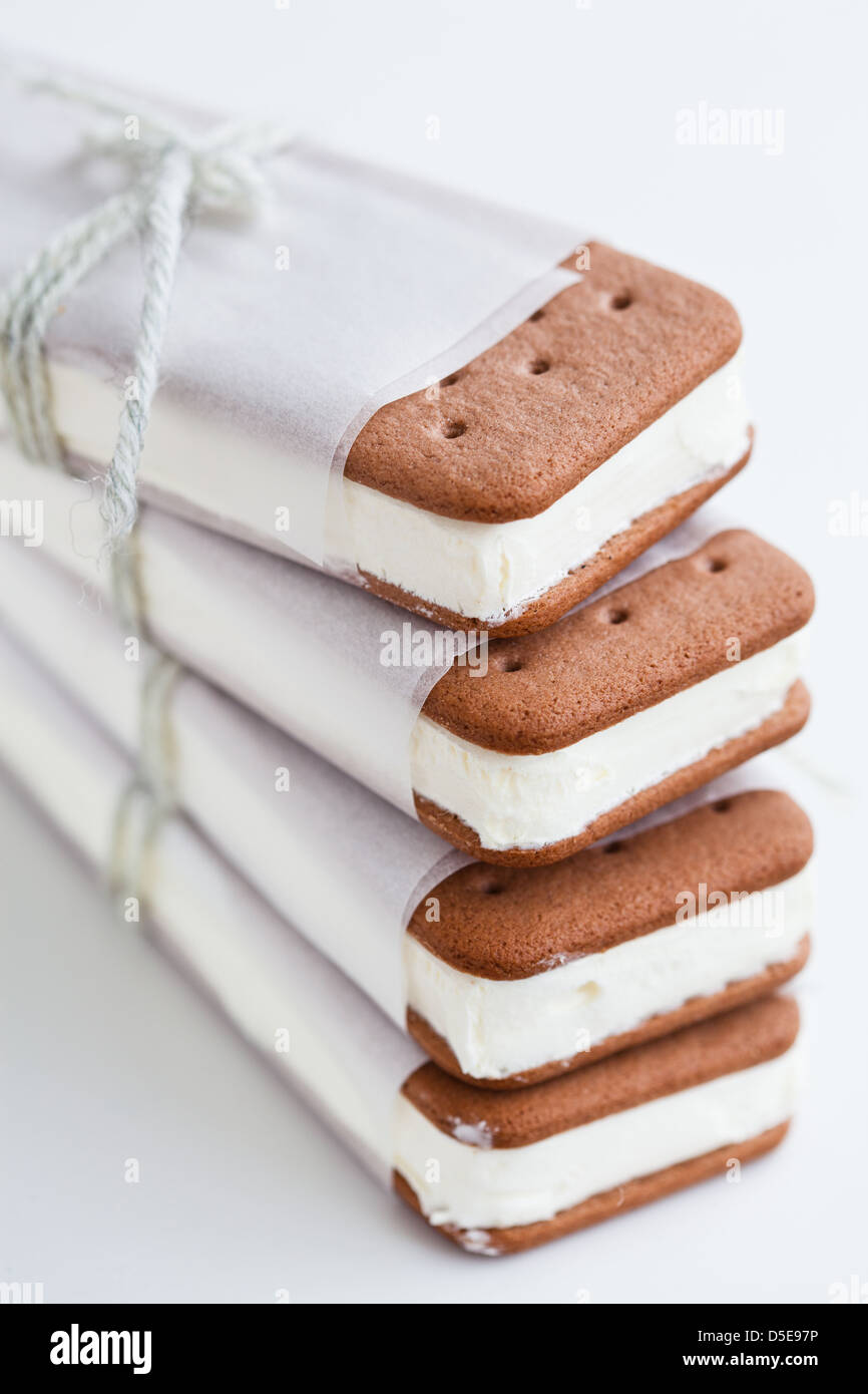 Closeup of stack of vanilla ice cream biscuits wrapped in white paper ...