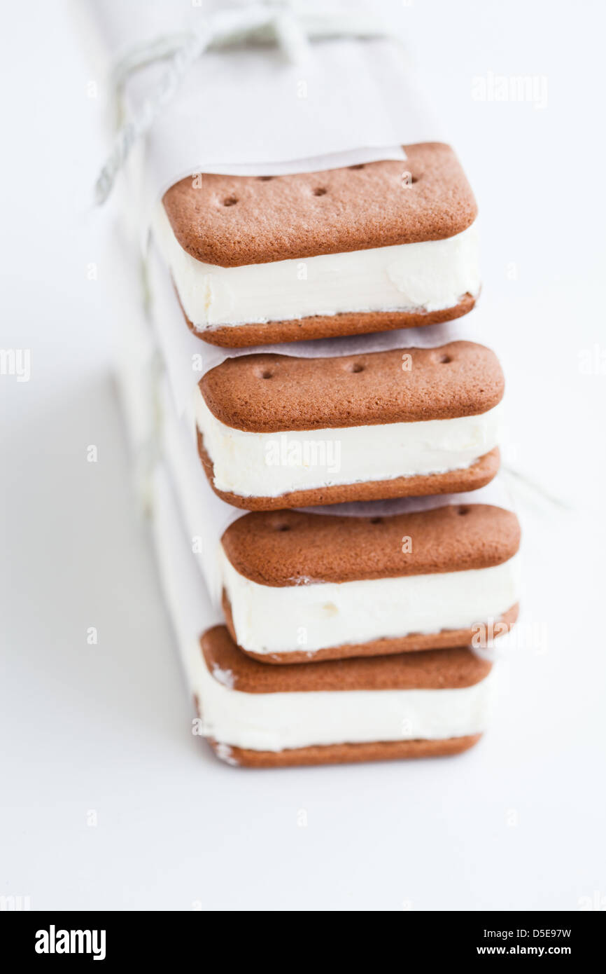 Closeup of stack of vanilla ice cream biscuits wrapped in white paper ...