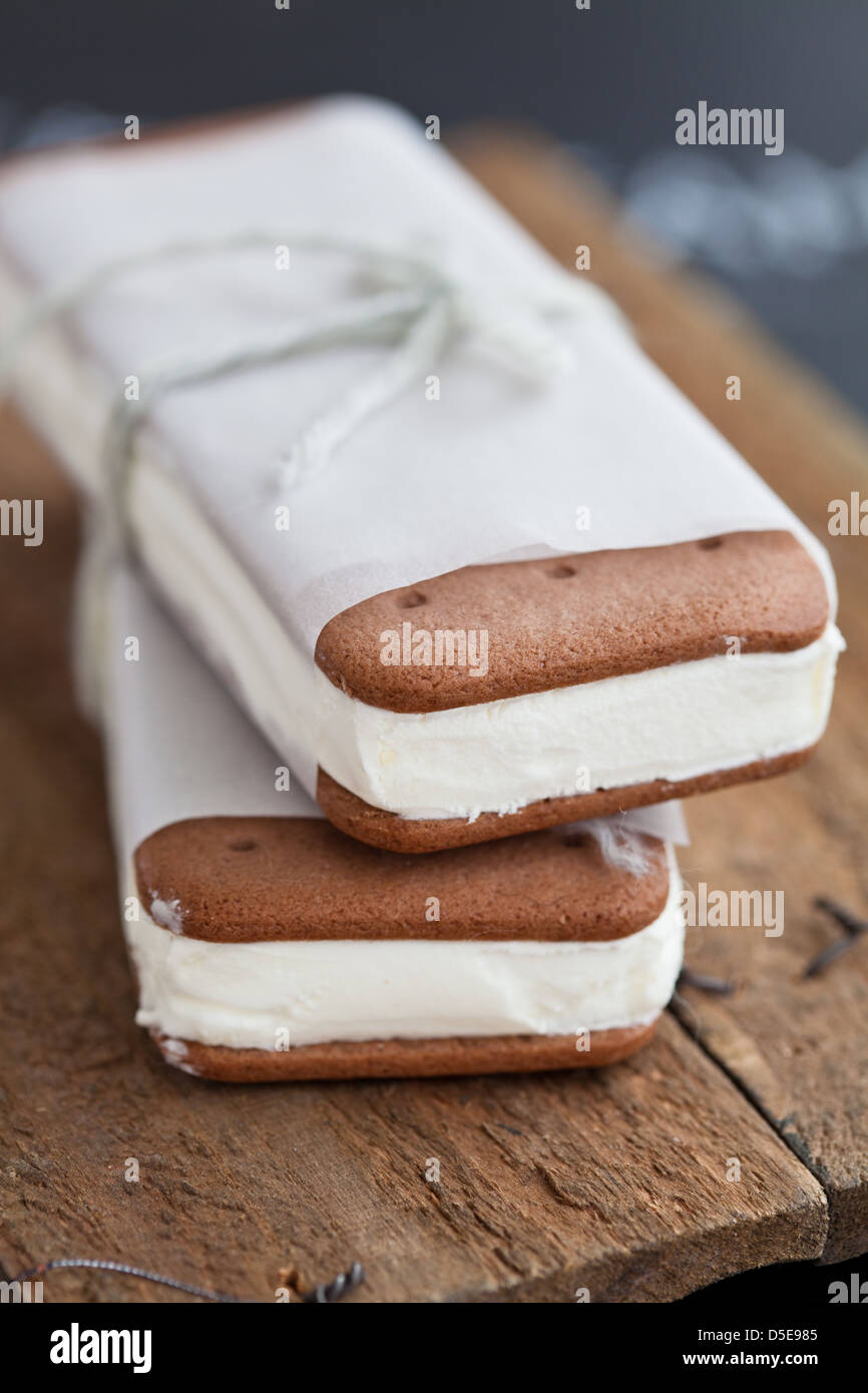Closeup of two ice cream biscuits wrapped in white paper with string ...
