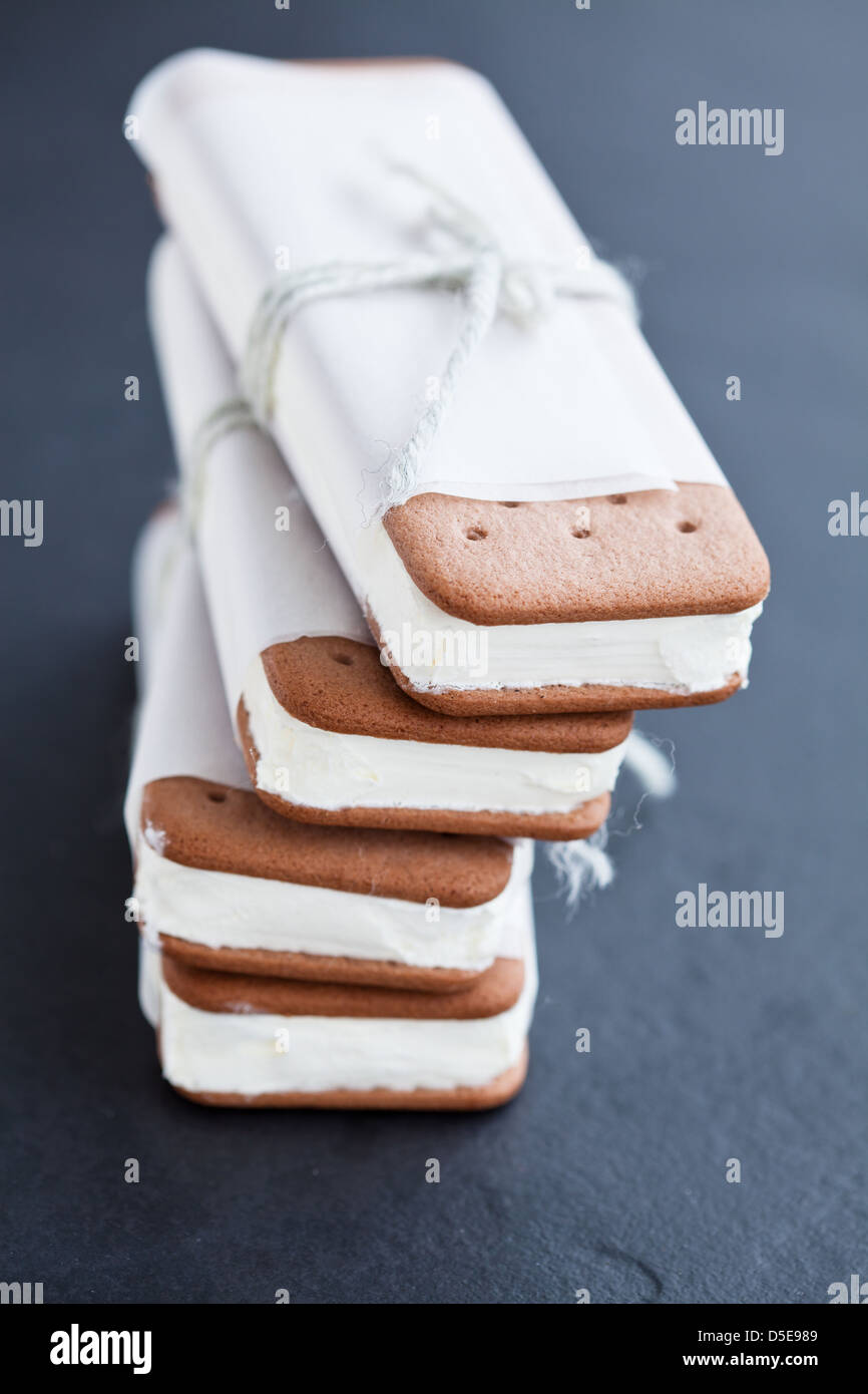 Closeup of stack of vanilla ice cream biscuits wrapped in white paper ...