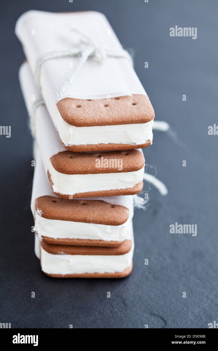 Closeup of stack of vanilla ice cream biscuits wrapped in white paper ...