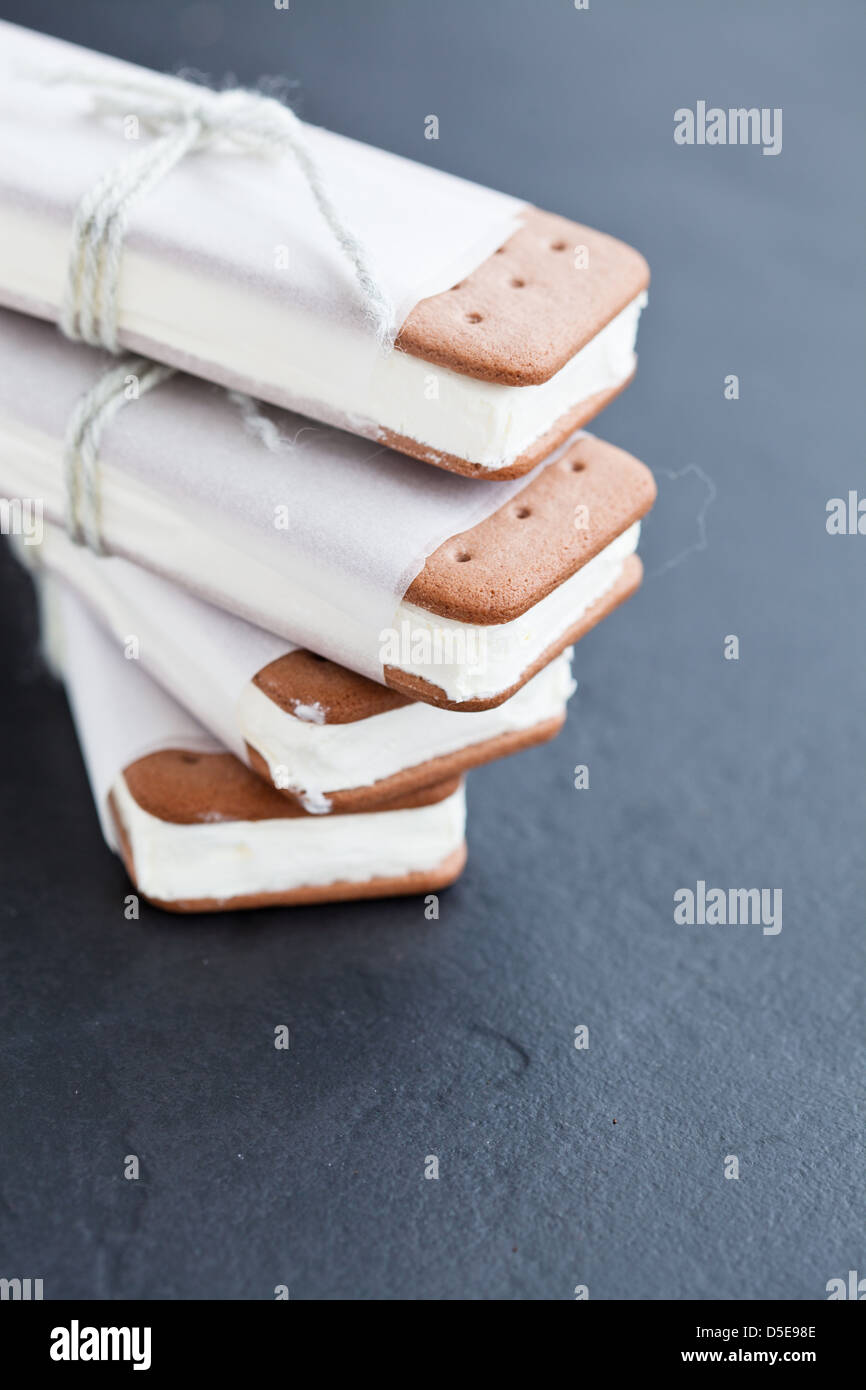 Closeup of stack of vanilla ice cream biscuits wrapped in white paper ...
