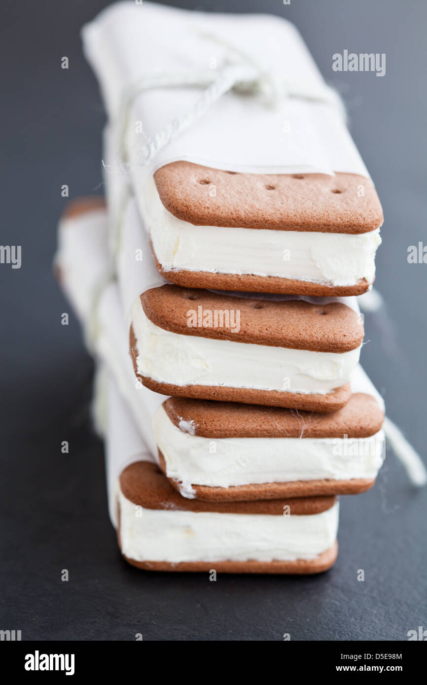 Closeup of stack of vanilla ice cream biscuits wrapped in white paper ...