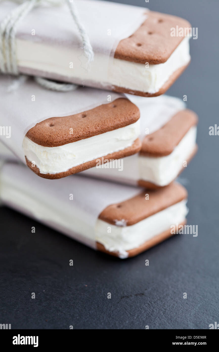 Closeup of stack of vanilla ice cream biscuits wrapped in white paper ...