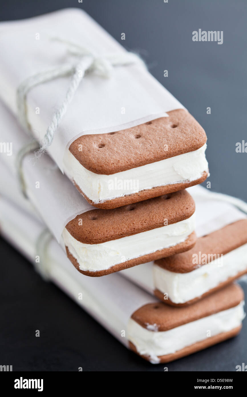 Closeup of stack of vanilla ice cream biscuits wrapped in white paper ...
