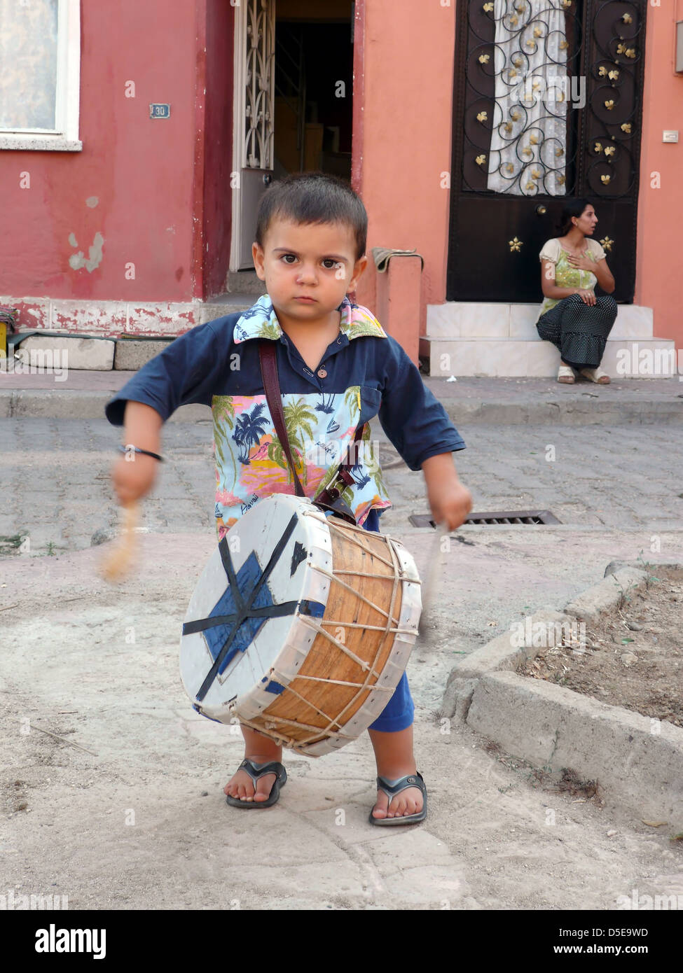 Little gypsy musician plays drum Stock Photo - Alamy