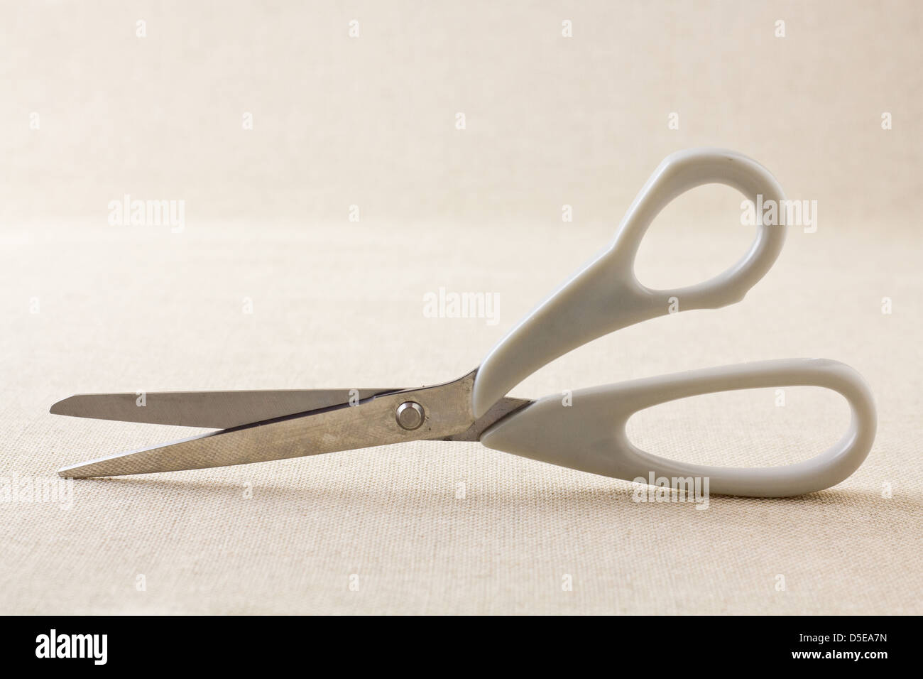 Grey metal scissors on hessian with copy space Stock Photo - Alamy