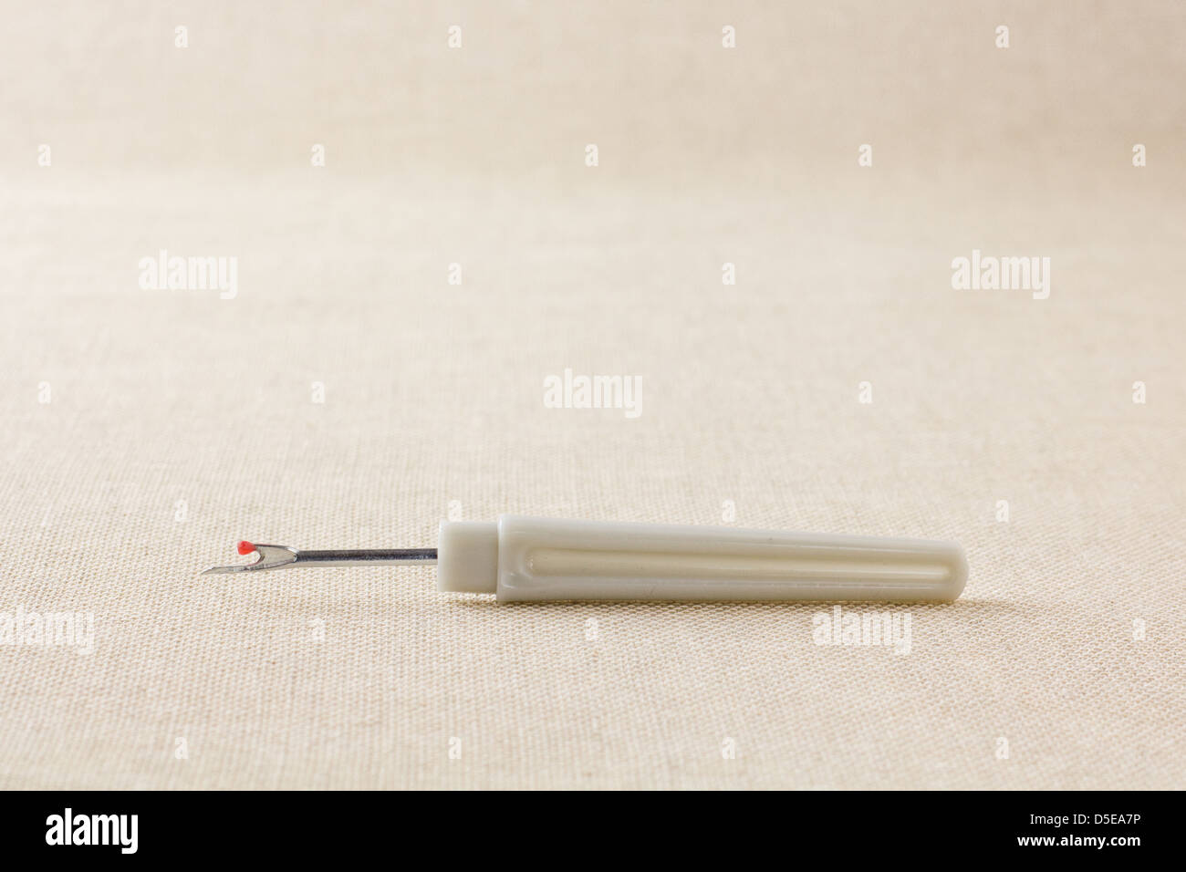 Seam ripper sewing tool on hessian with copy space Stock Photo - Alamy
