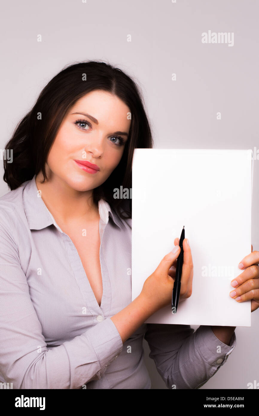Young professional business women female with pen and pad in an office ...