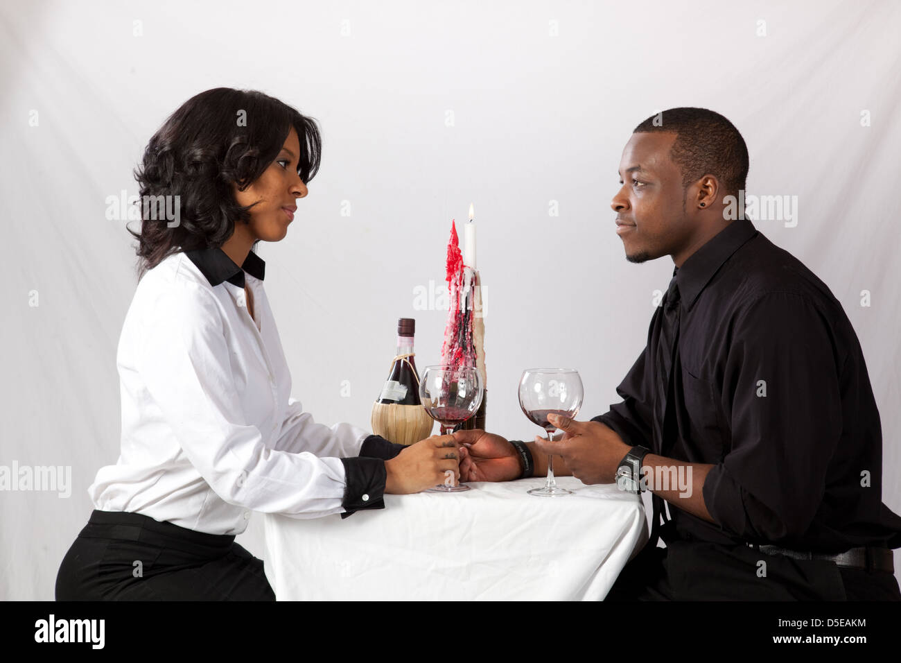 Romantic couple sitting at a table, talking and sharing a moment of ...