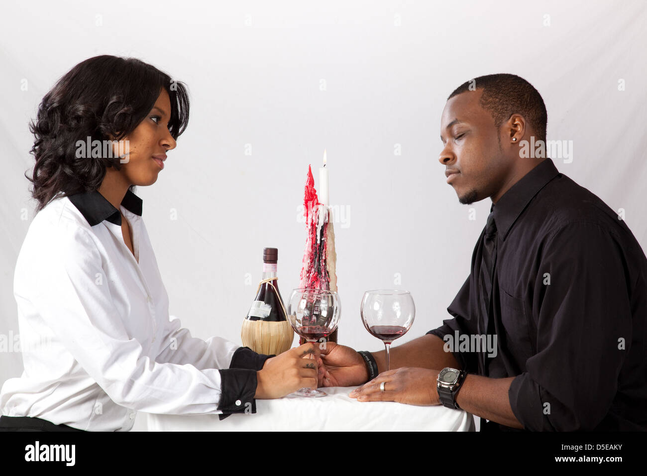 Romantic couple sitting at a table, talking and sharing a moment of ...