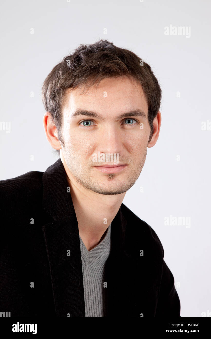 Handsome Caucasian man in sports coat looking at the camera with a ...