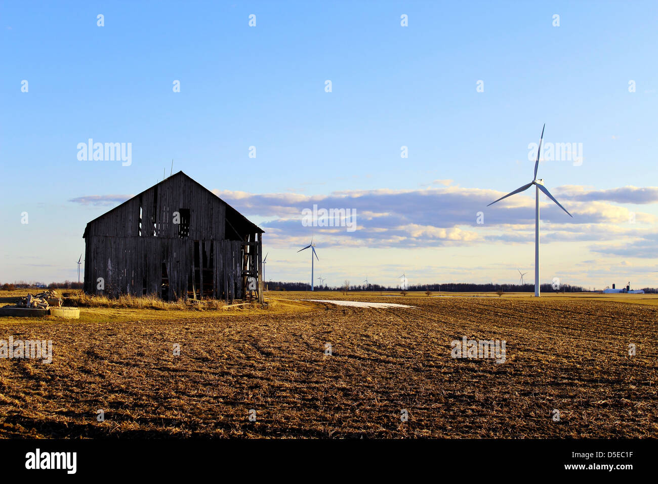 Wind turbines with barn and fields in the foreground Stock Photo - Alamy