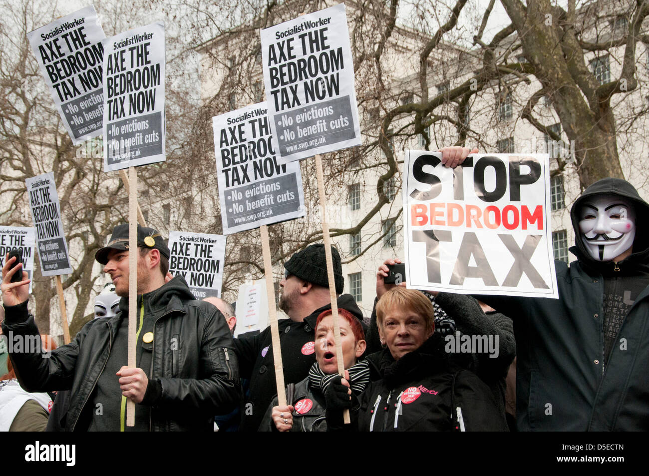 London, UK. 30/03/13. Anti-Bedroom Tax protesters wearing Anonymous ...