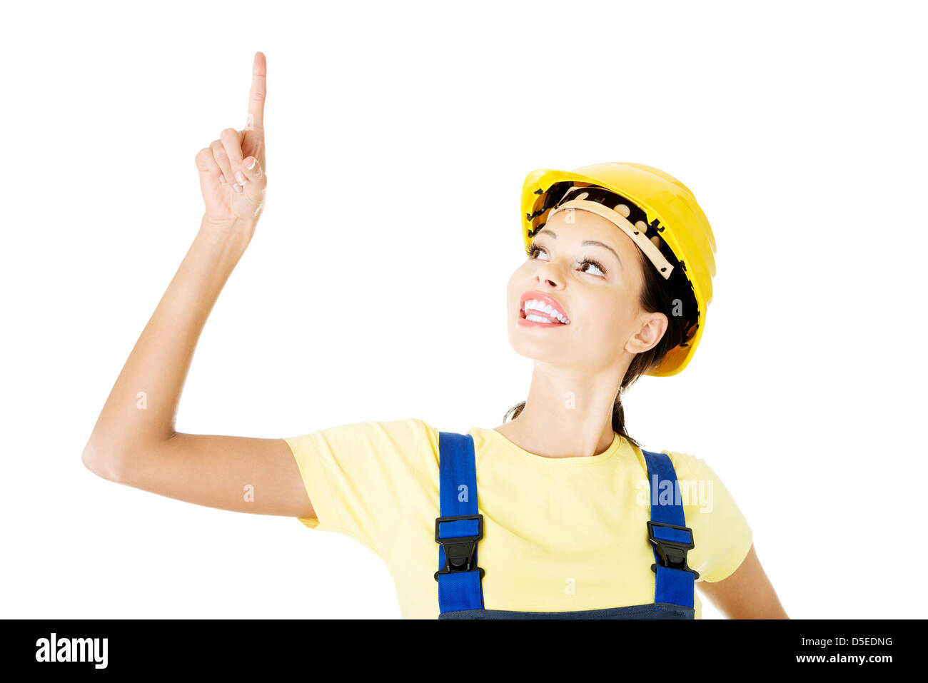 Female construction worker pointing on copy space, isolated on white ...