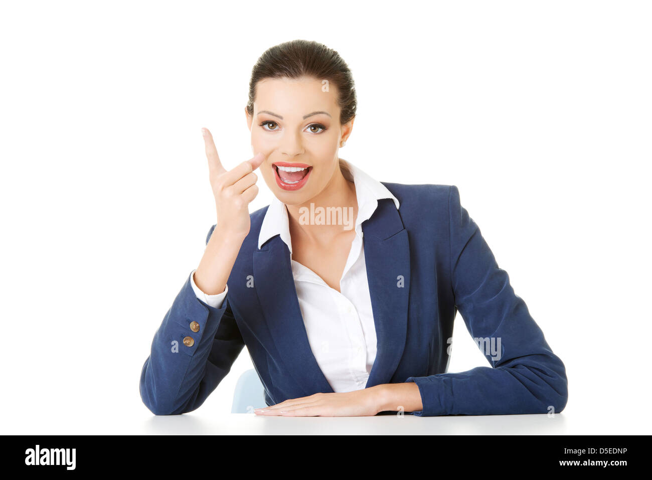 Business woman sitting at the desk and pointing with finger to empty ...