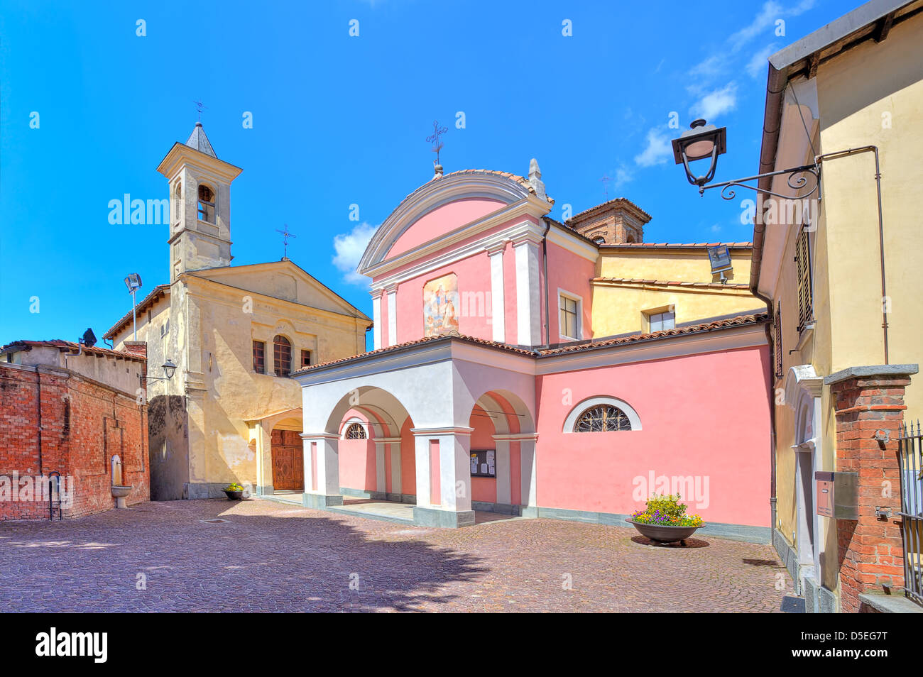 Two churches next to each other on small cobbled plaza in town center ...
