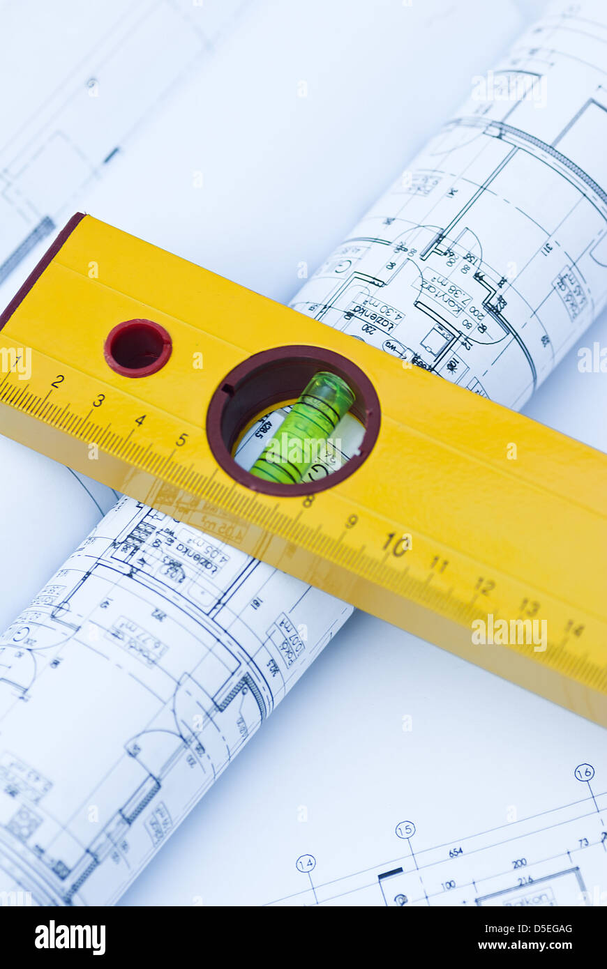 Construction rolls and plans and yellow helmet Stock Photo - Alamy