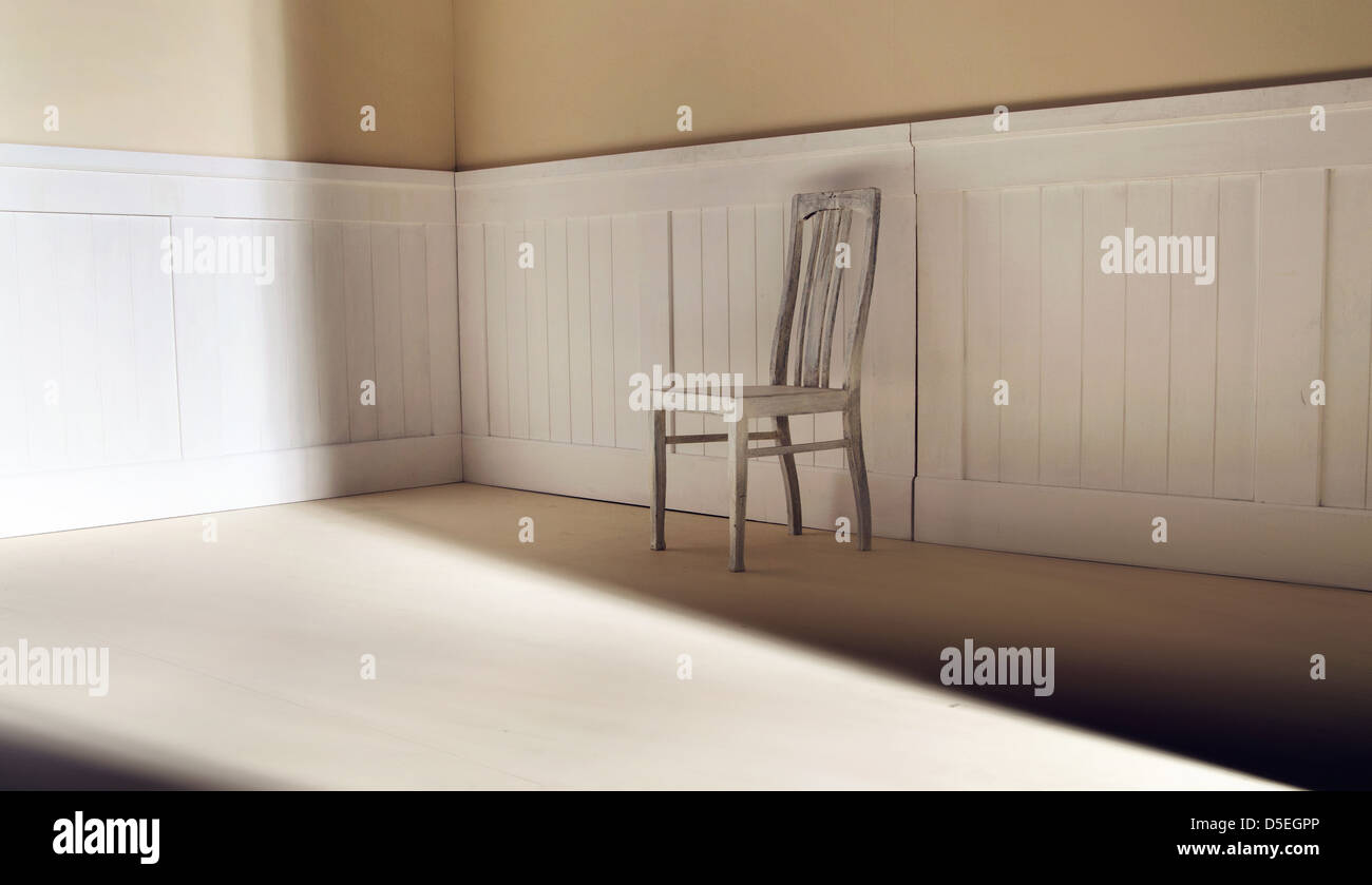 Bright interior with old chair against wall Stock Photo - Alamy