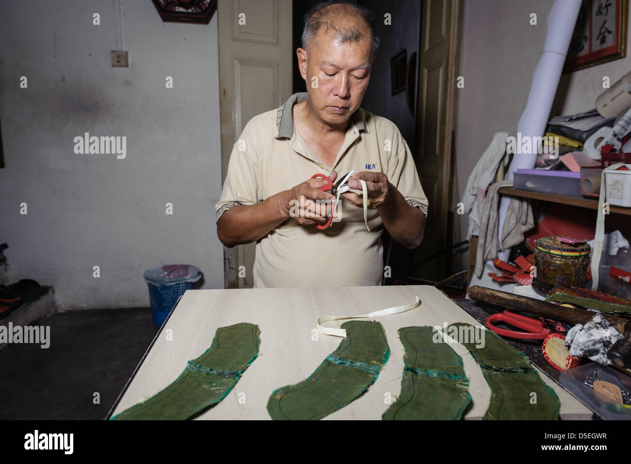 Artisan making shoes for "bound feet", Melaka, Malaysia, Asia Stock ...